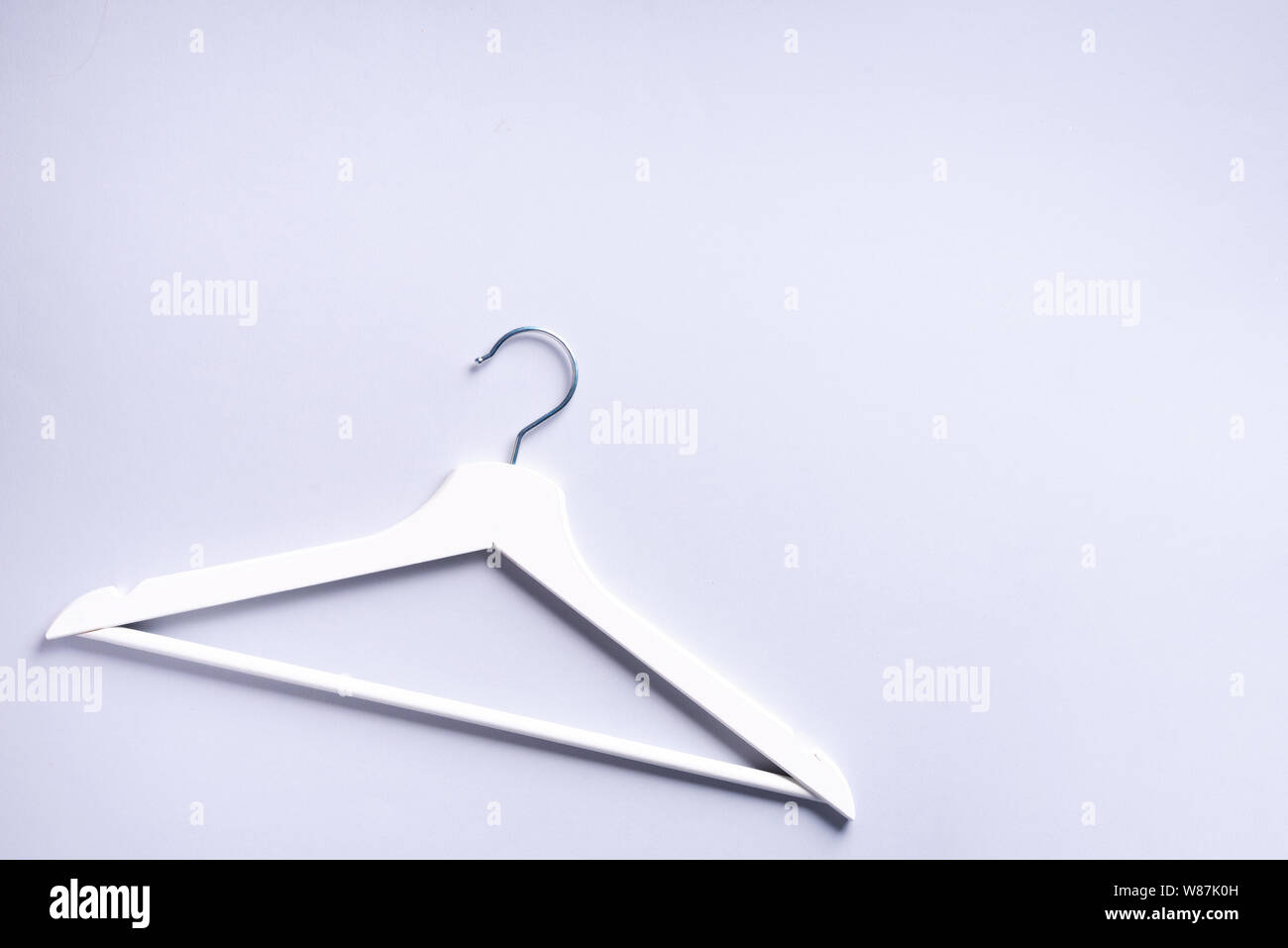 Top view of white clothes hangers on grey background with copy space ...
