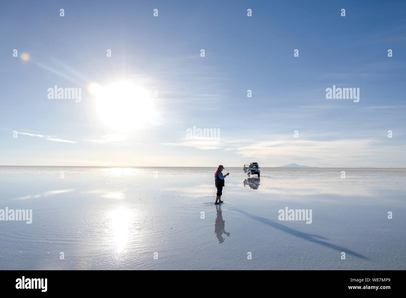 Water mirror in Salar de Uyuni, Uyuni, Bolivia : Tourists reflects in ...