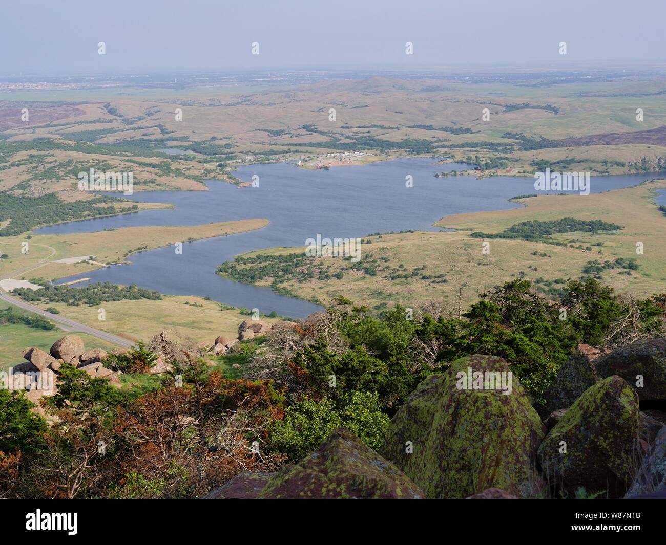 Wide aerial view of Lake Lawtonka, seen from peak of Mt. Scott ...