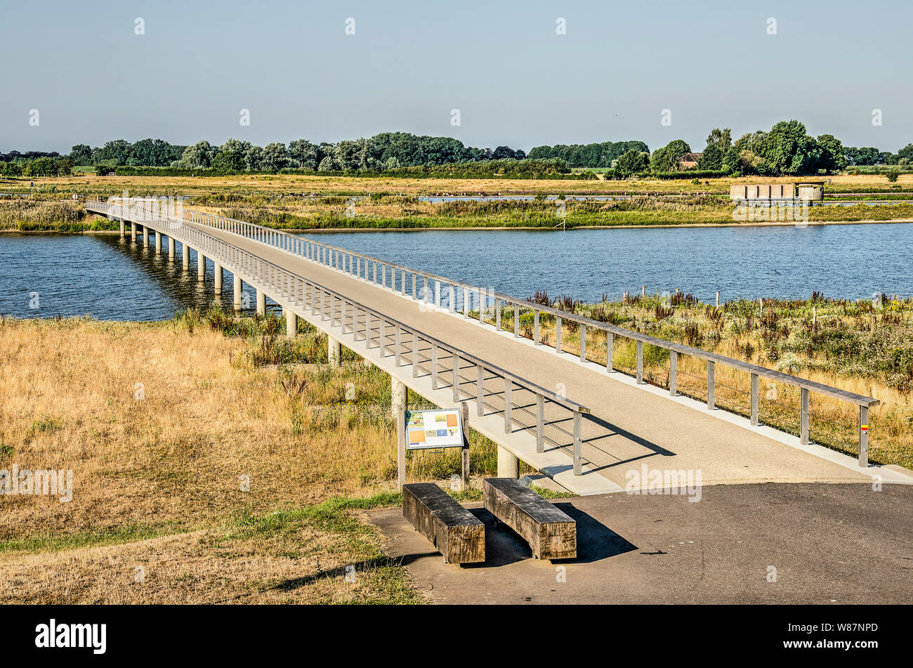 New concrete bridge for pedestrians and cyclists across a new channel ...