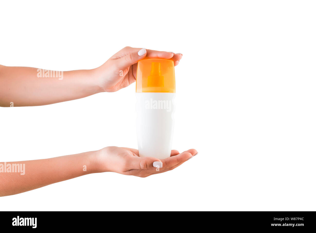 Female hand holding cream bottle of lotion isolated. Girl give cosmetic ...