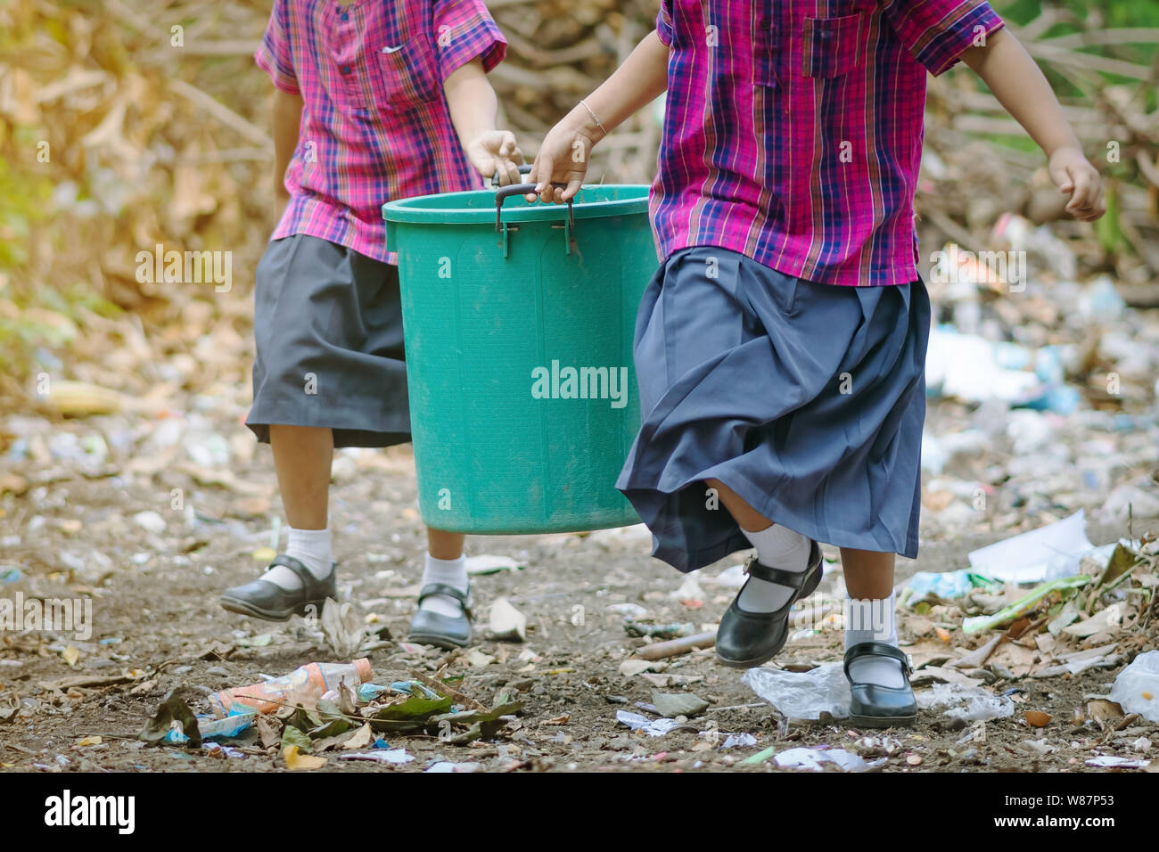 Female Students help to remove rubbish from the classroom to pile waste ...