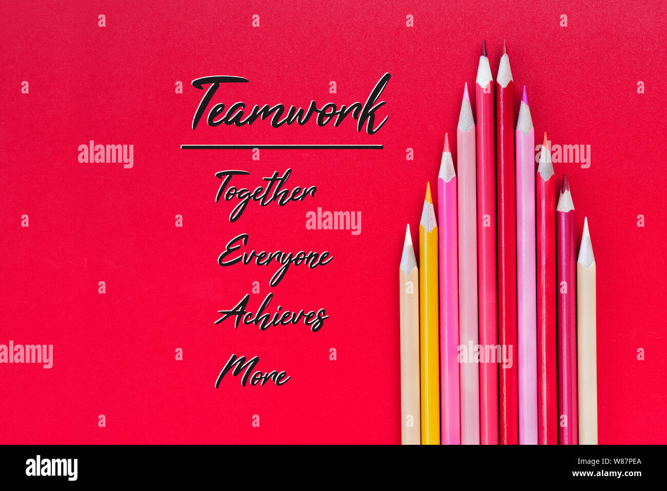 Teamwork concept. group of color pencil on red background with word ...