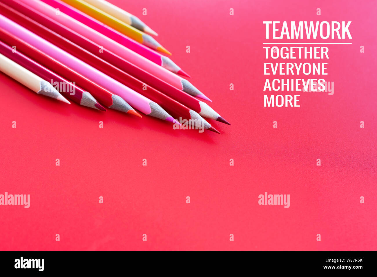 Teamwork concept. group of color pencil on pink background with word ...