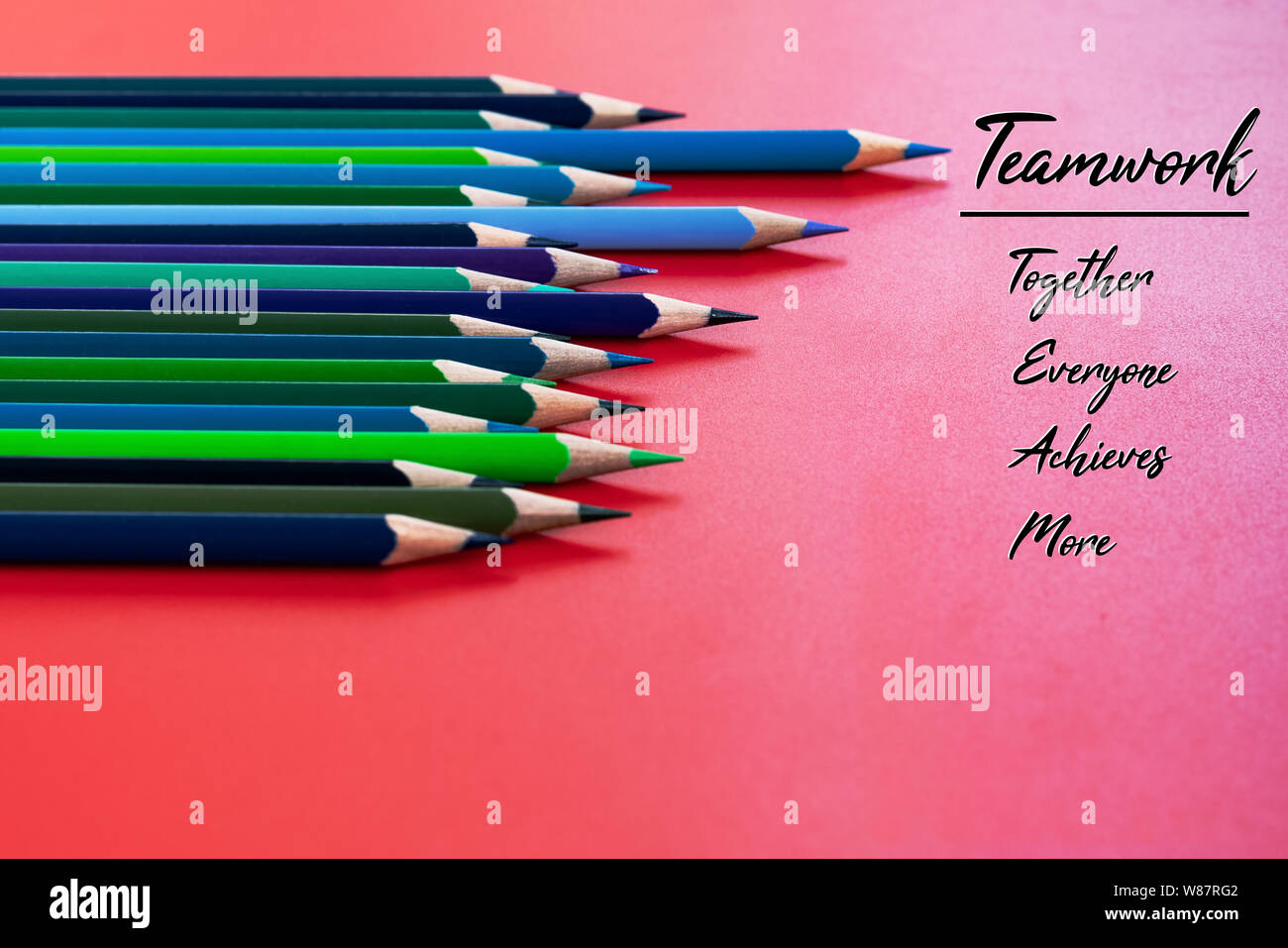 Teamwork concept. group of color pencil on red background with word ...