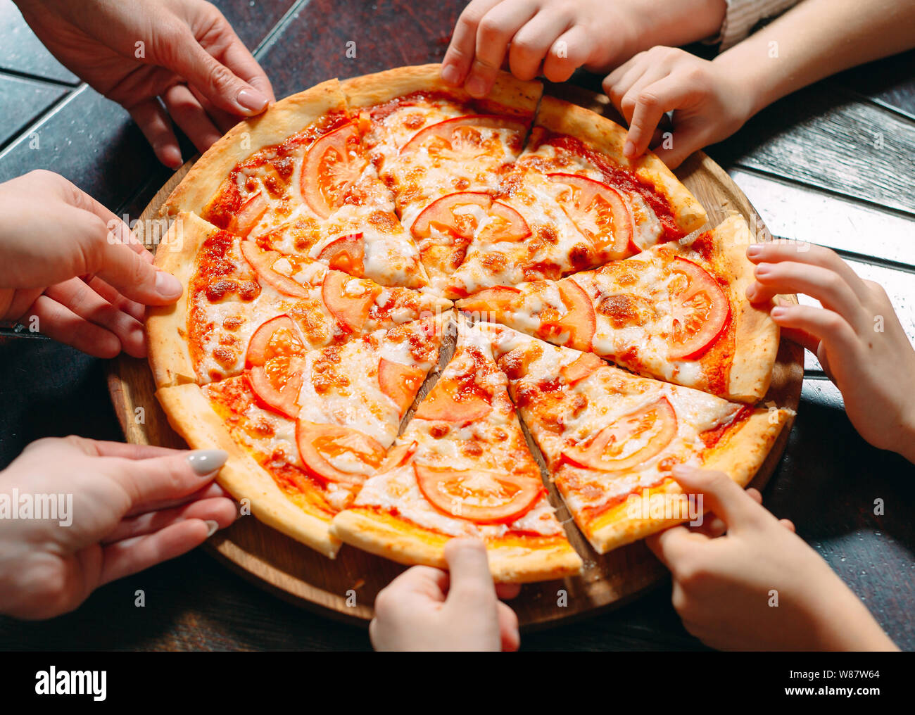 Hands grabbing slices cheese pizza hi-res stock photography and images ...