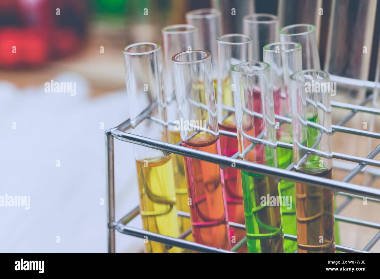 Stand with test tubes isolated on white. Several chemical solution in ...