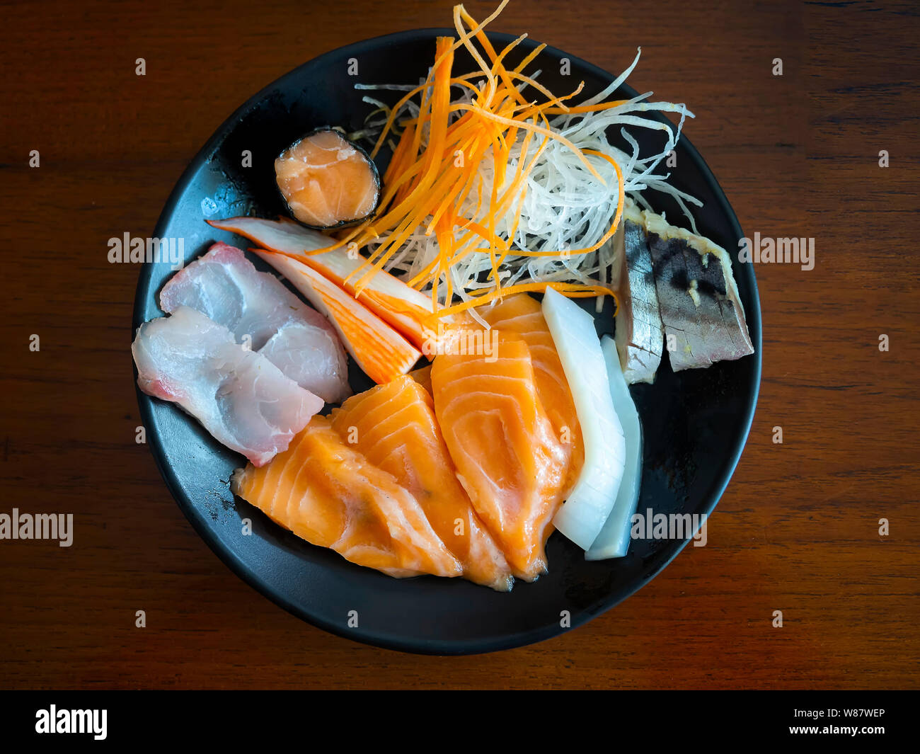 Top view of Various of raw fish sashimi on black dish, Japan food Stock ...