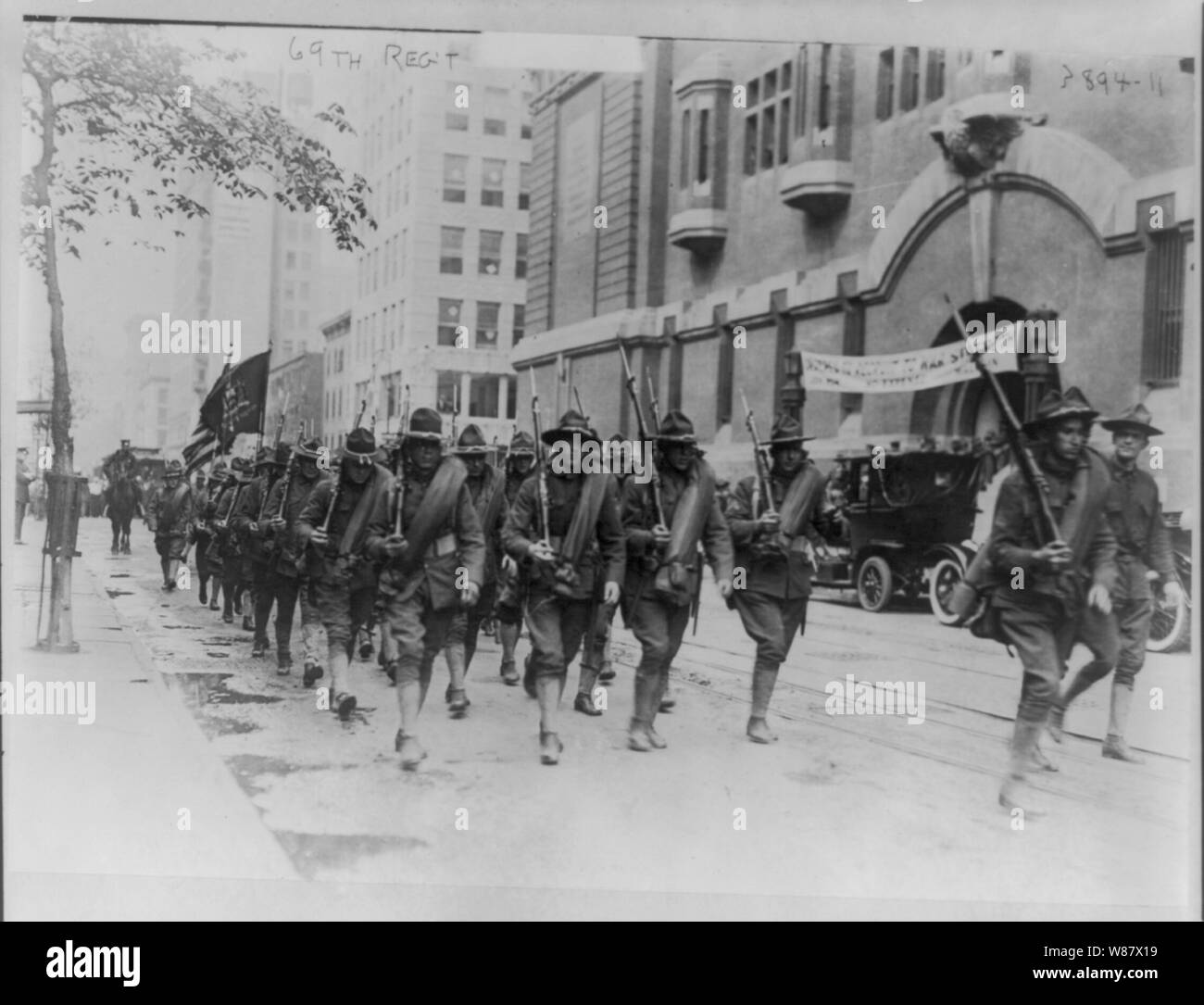69th Regiment, New York National Guard, marching past armory entrance ...