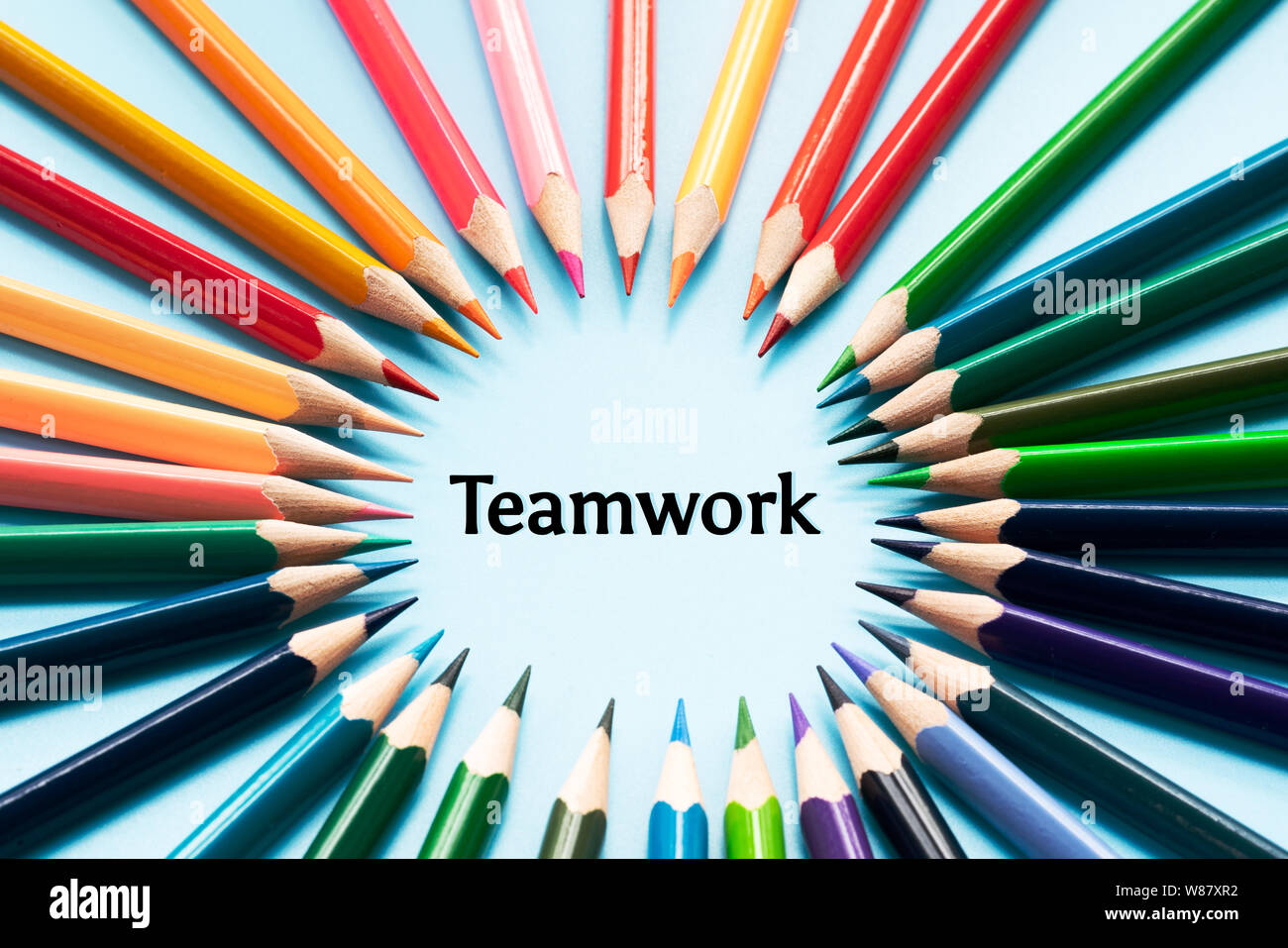 Teamwork concept. group of color pencil on blue background Stock Photo ...