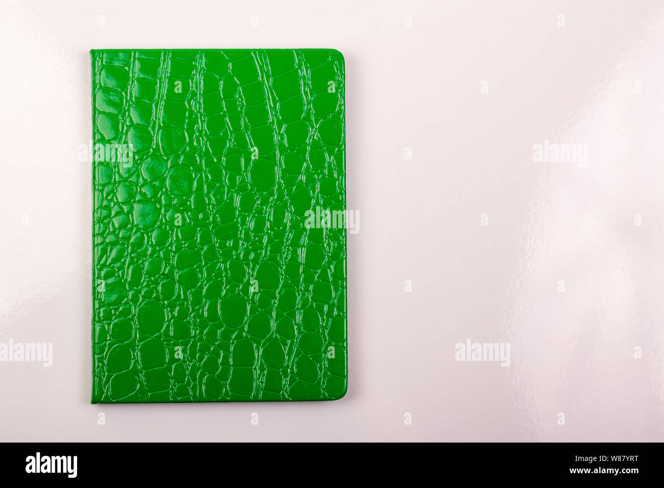 Green notebook on white background. Closed diary Stock Photo - Alamy