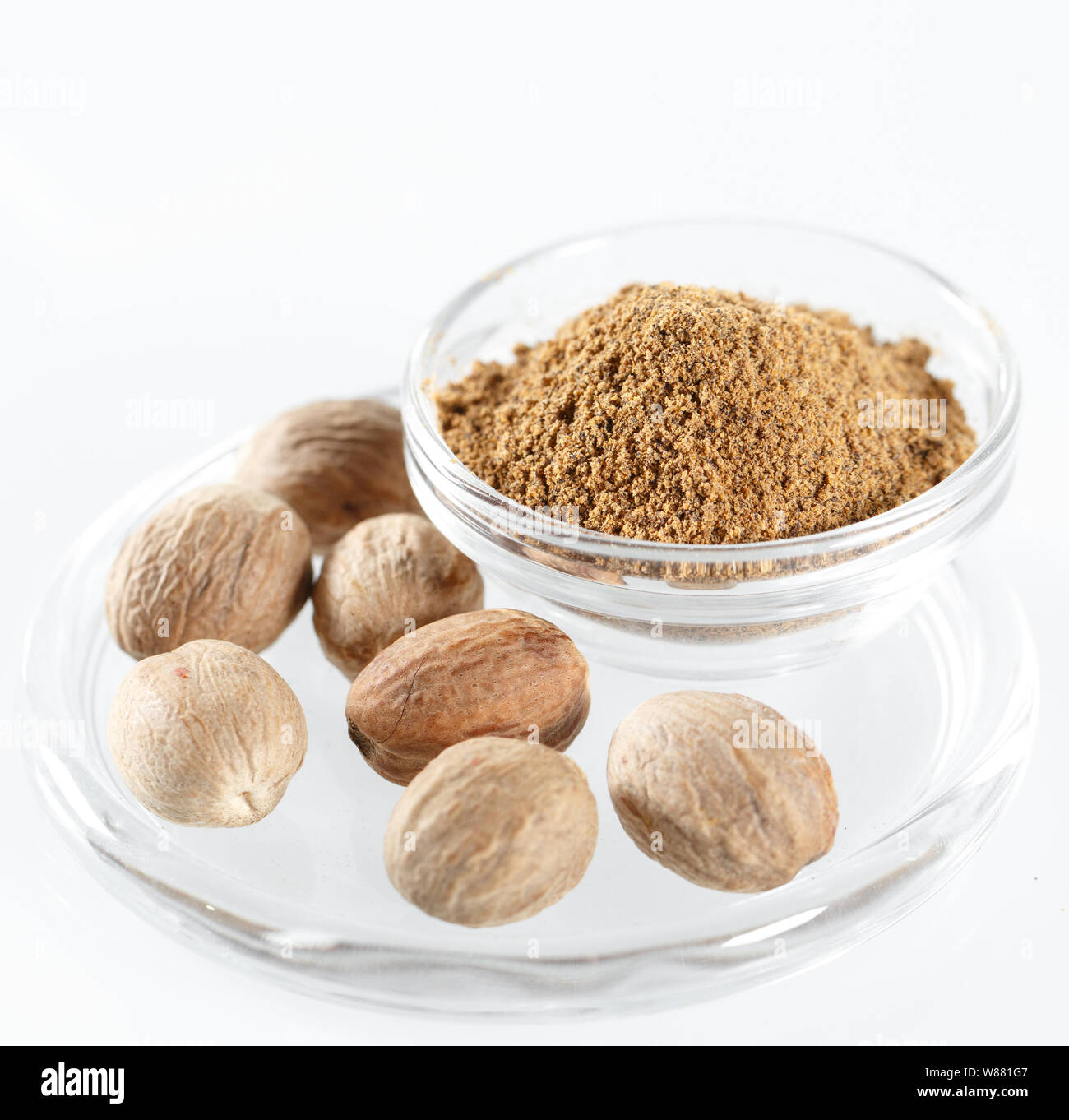 Nutmeg Isolated on the white background in a plate Stock Photo - Alamy