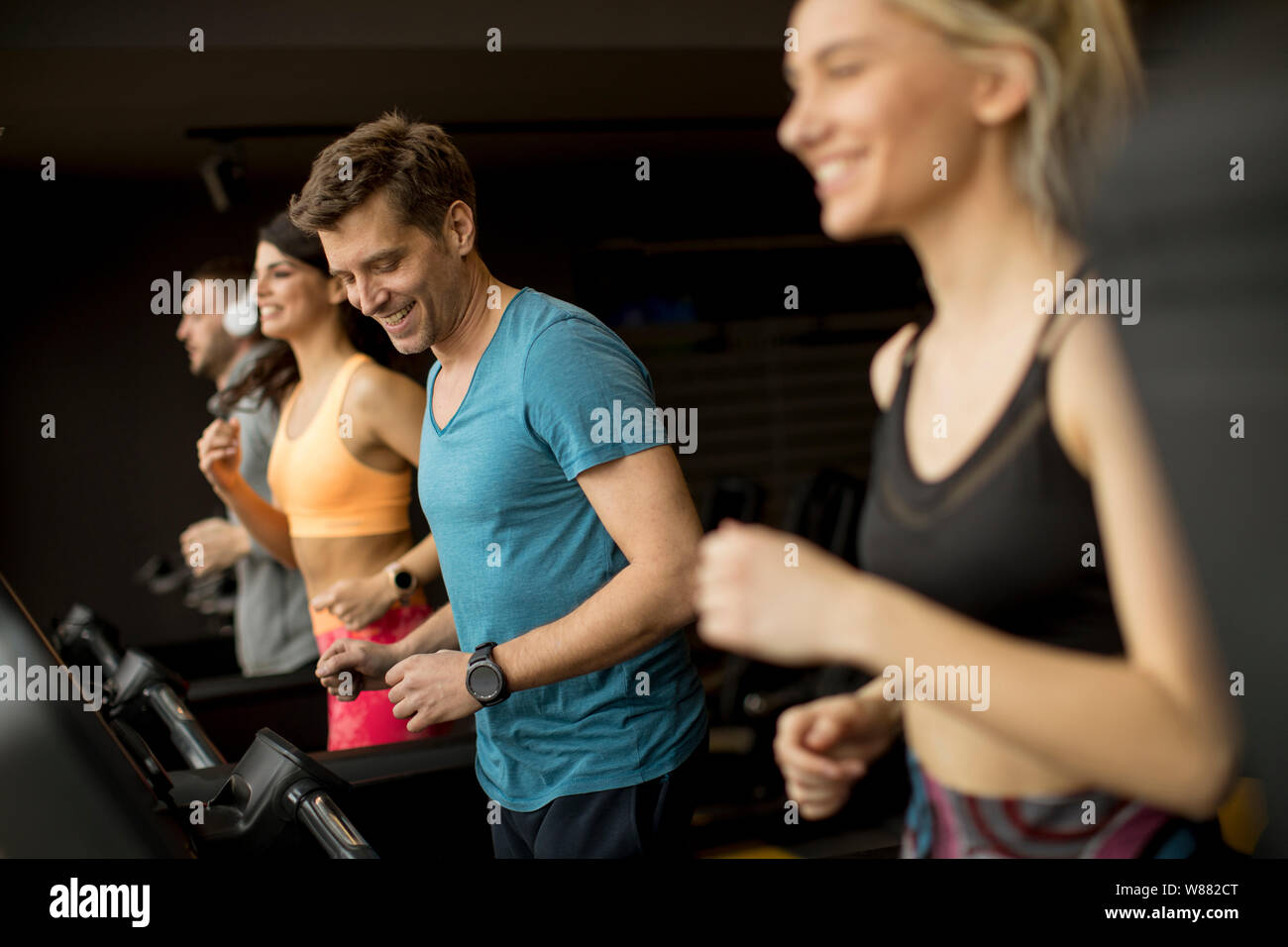 Group of young people using threadmill in modern gym Stock Photo - Alamy