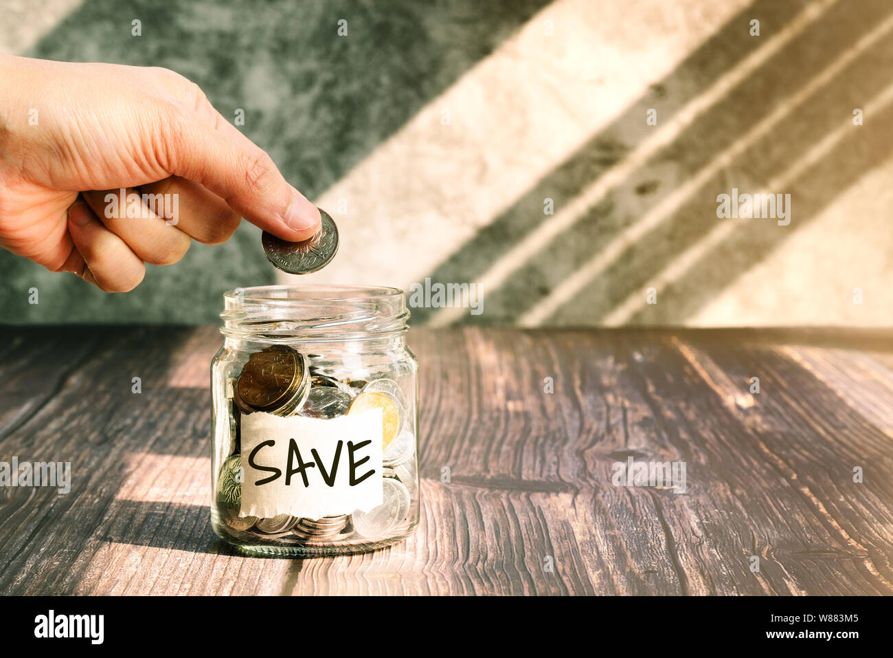 save money, woman put coins in glass jar for money saving financial ...