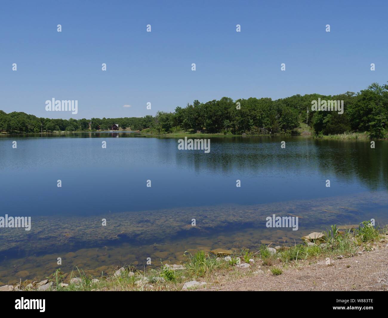 Wide, side view shot of a lake at Chickasaw National Recreation Area in ...