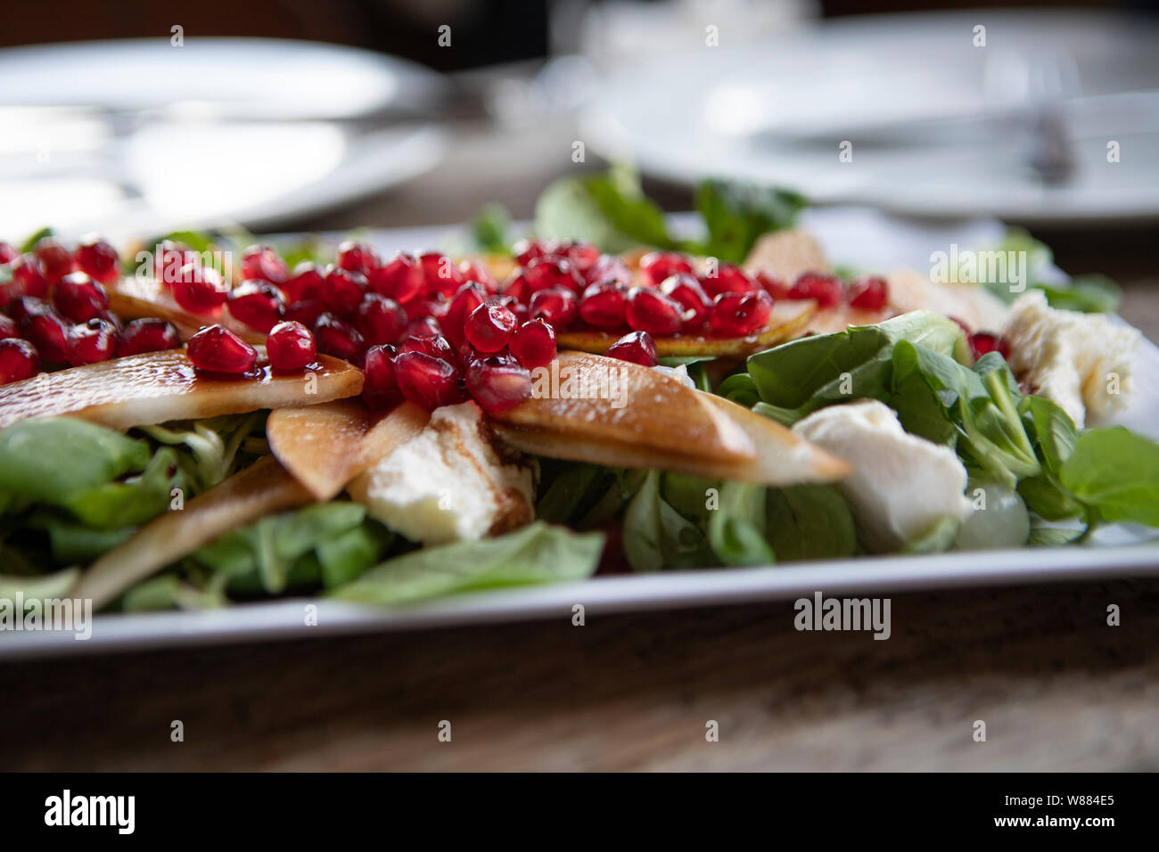 plate with green salat, pomegranate and fungi Stock Photo - Alamy