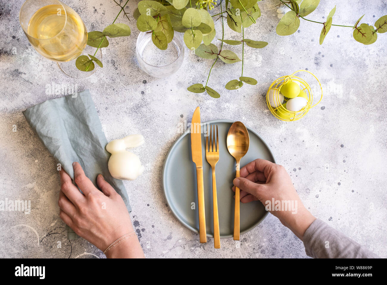 Happy Easter table setting: bunny, mint green plate and woman hands ...