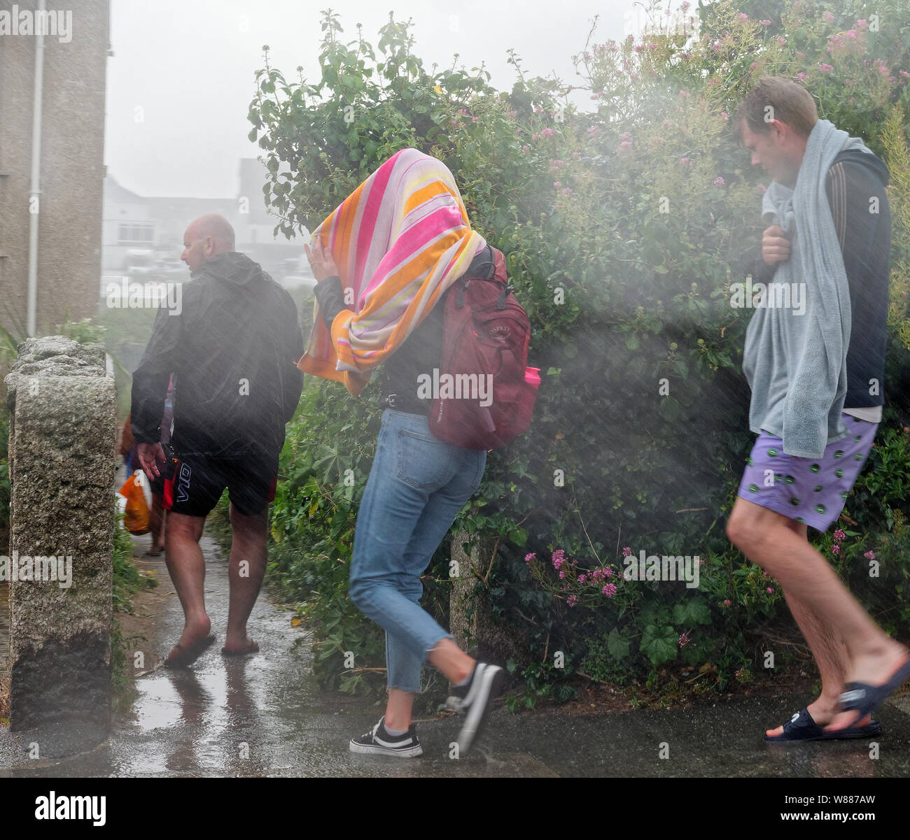 Group single file rain soaked hi-res stock photography and images - Alamy