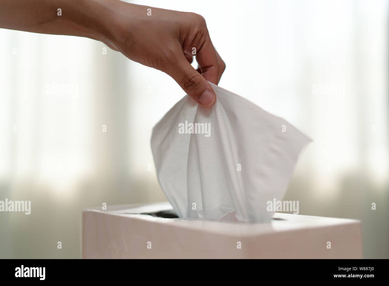 women hand picking napkin/tissue paper from the tissue box Stock Photo ...