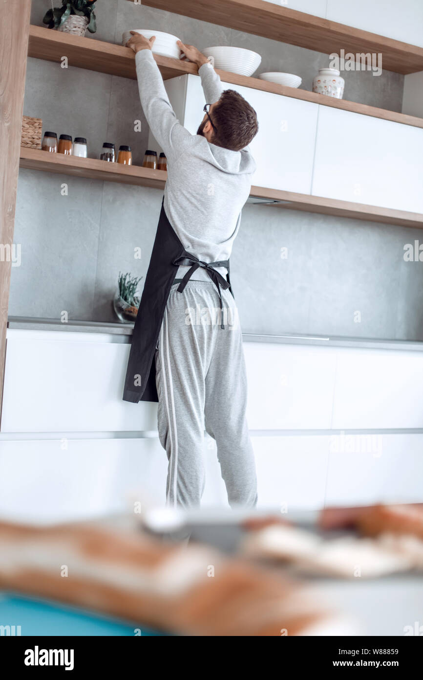 smiling man choosing spices in the kitchen Stock Photo - Alamy
