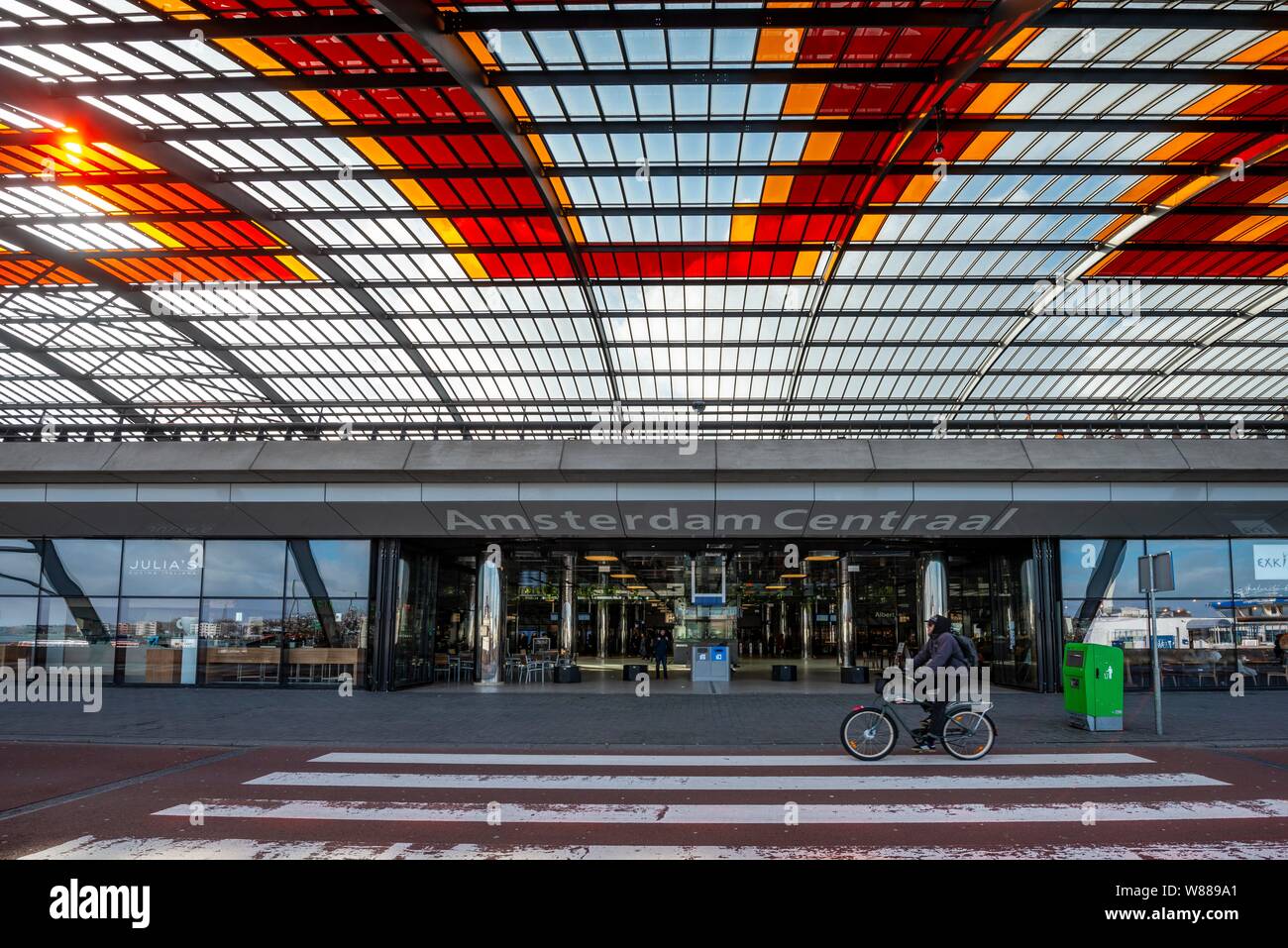 Cyclists on zebra crossing, Amsterdam Centraal, central station ...