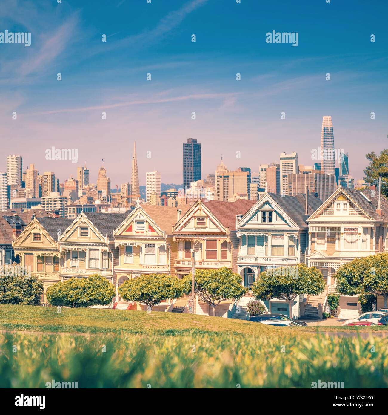 Famous row of colorful houses in San Francisco overlooking Downtown ...