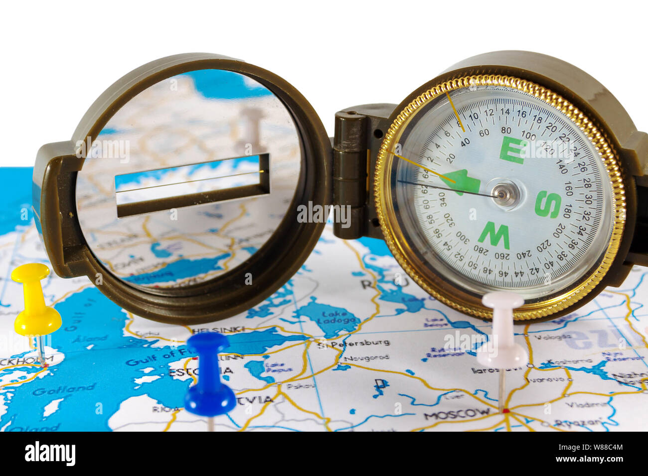 Magnetic compass on a world map conceptual of global travel , tourism ...