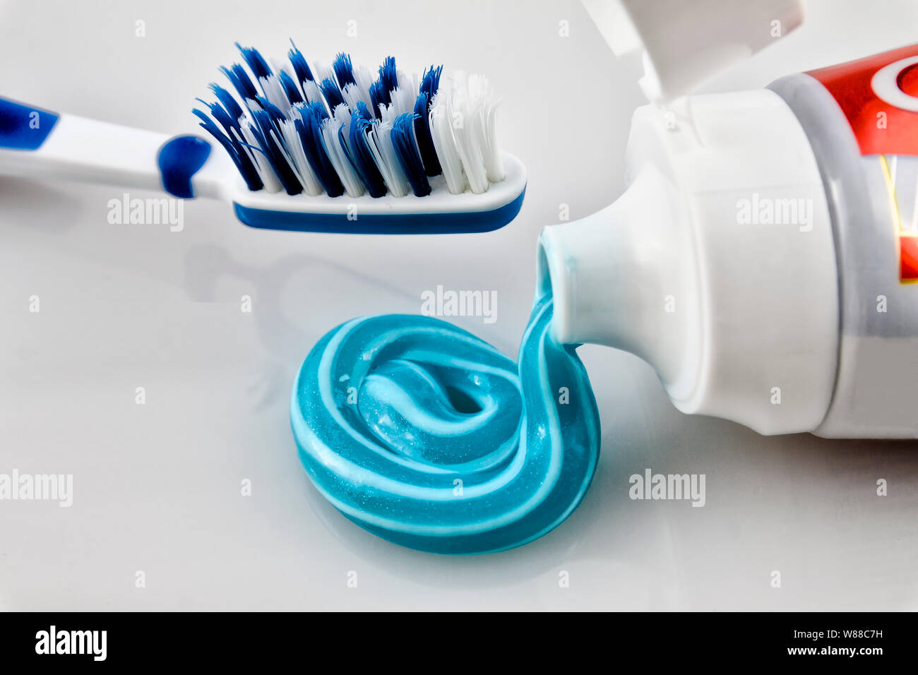Toothpaste in a tube with a toothbrush Stock Photo - Alamy