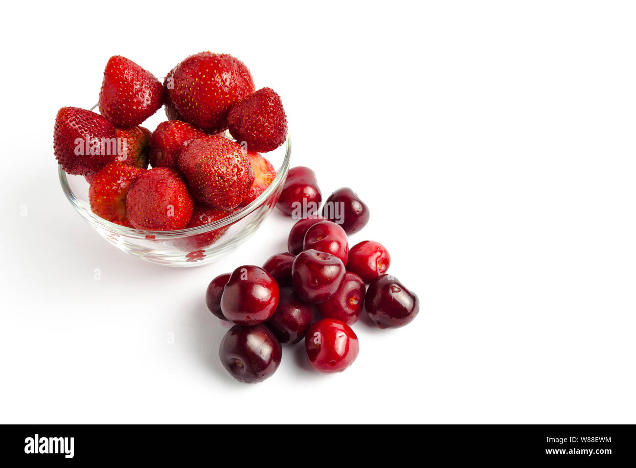 Strawberries with cherries on a white background Stock Photo - Alamy