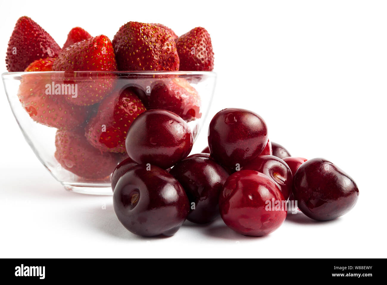 Strawberries with cherries on a white background Stock Photo - Alamy