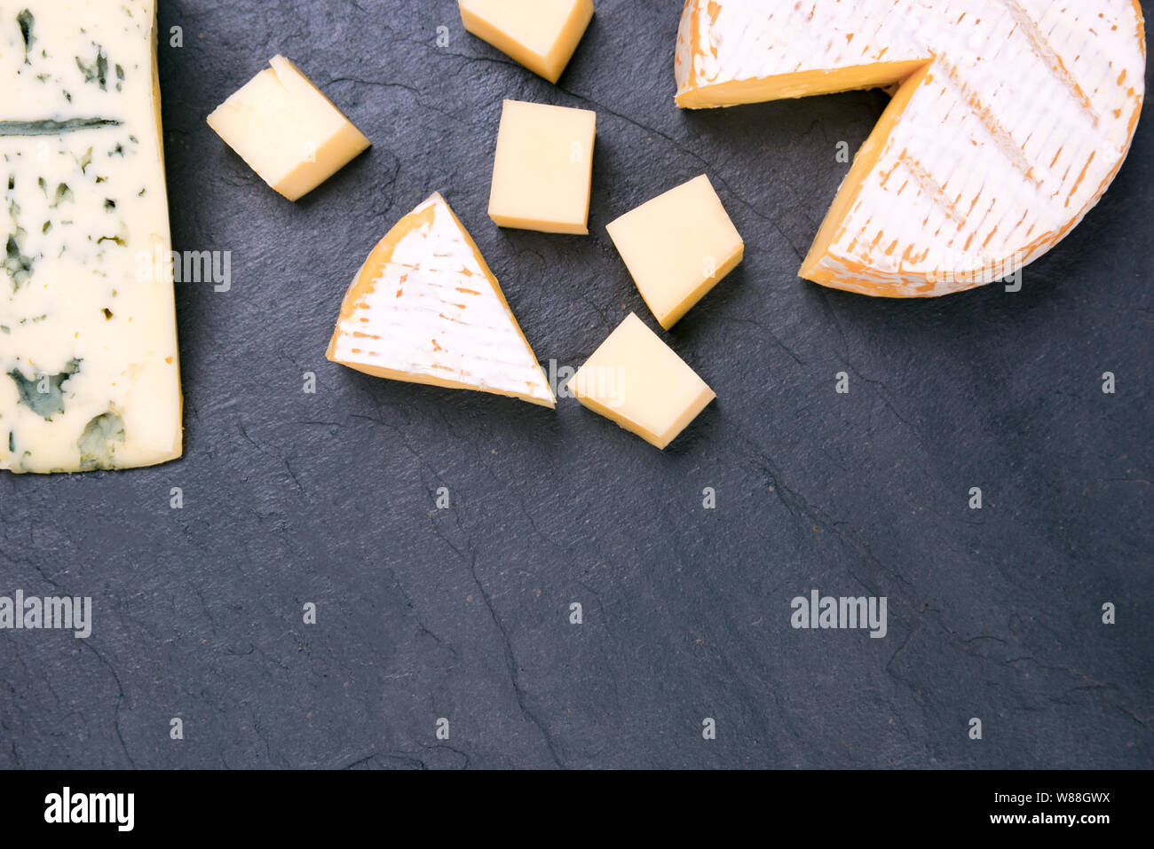 different types of cheese in on dark stone background Stock Photo - Alamy