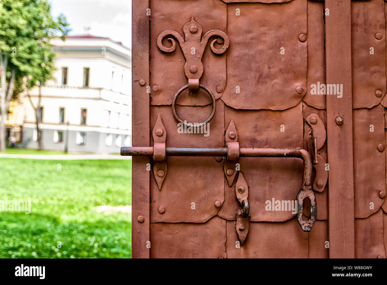 fragment of wooden doors with rusty gate and lock Stock Photo - Alamy