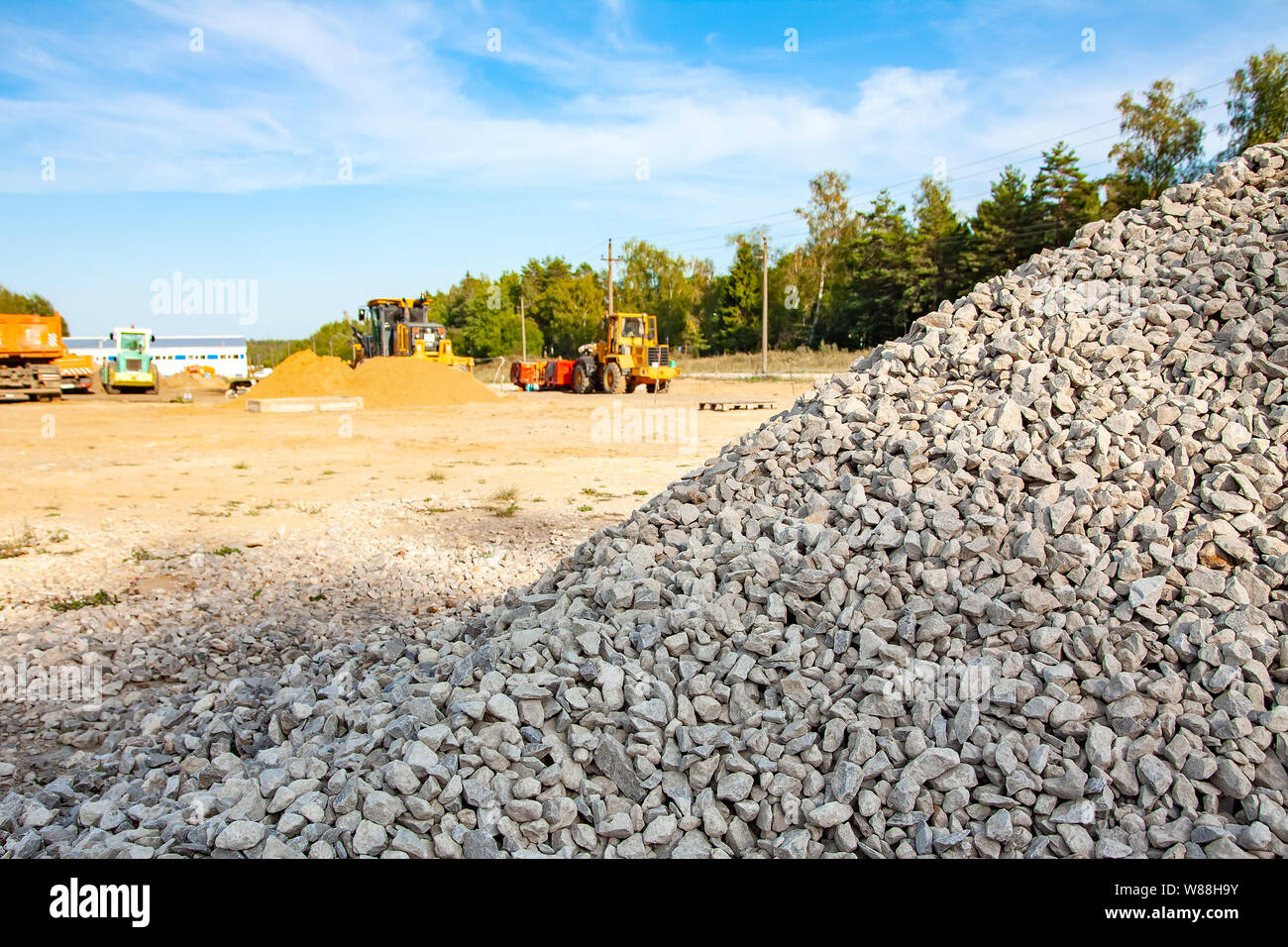 A fine gray graphite gravel is piled high on the background of ...
