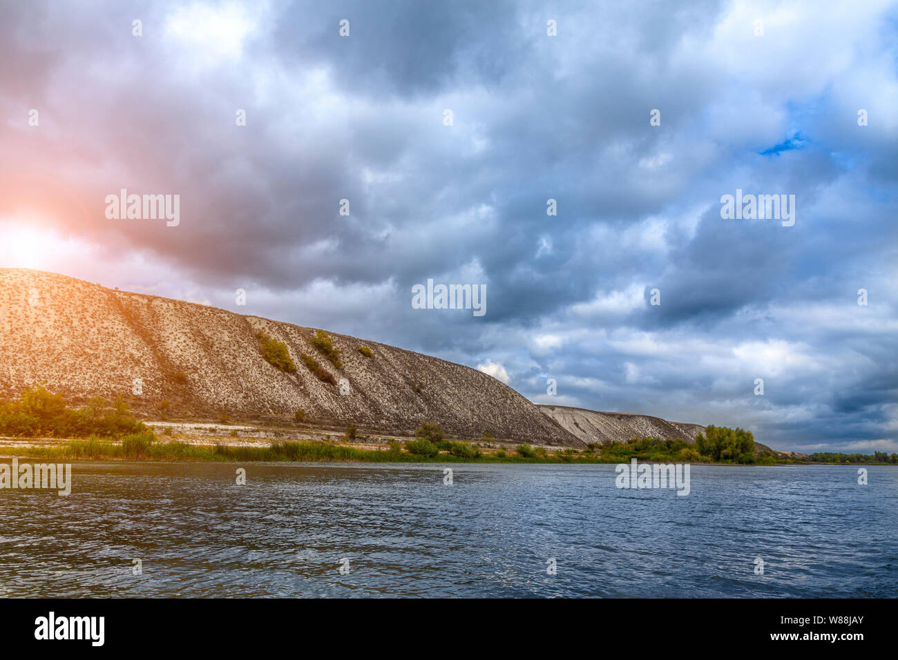 Picturesque bank of the river with clouds over the water Stock Photo ...