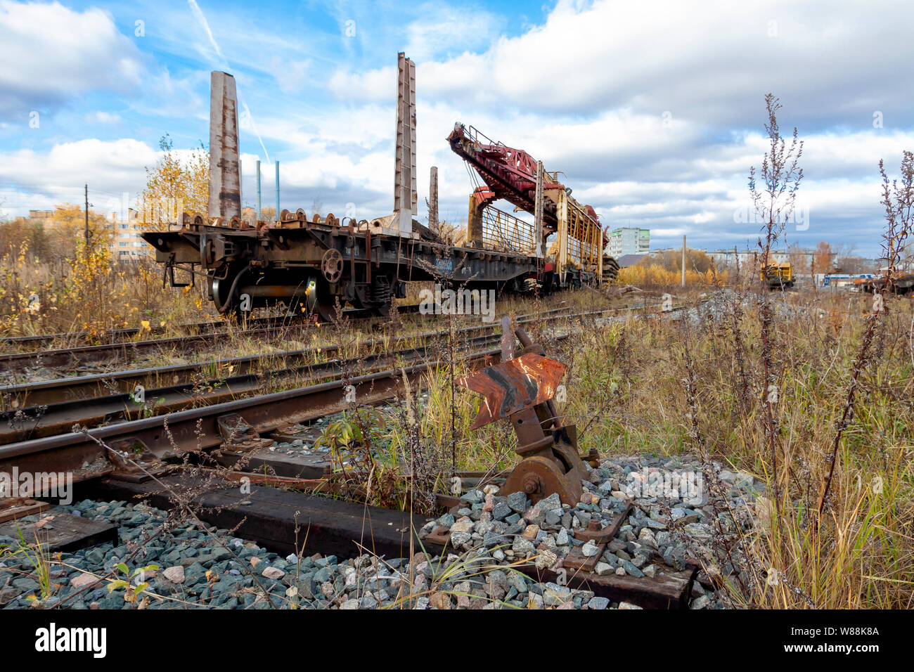 An old railway track laying machine stands on an abandoned old railway ...