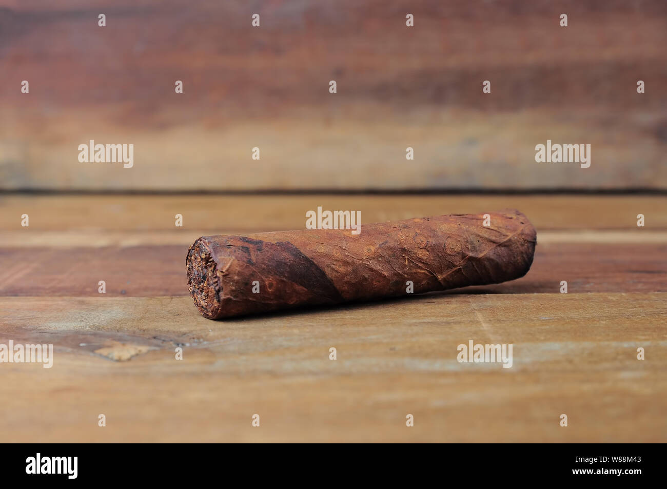 Cigars on wooden background Stock Photo - Alamy