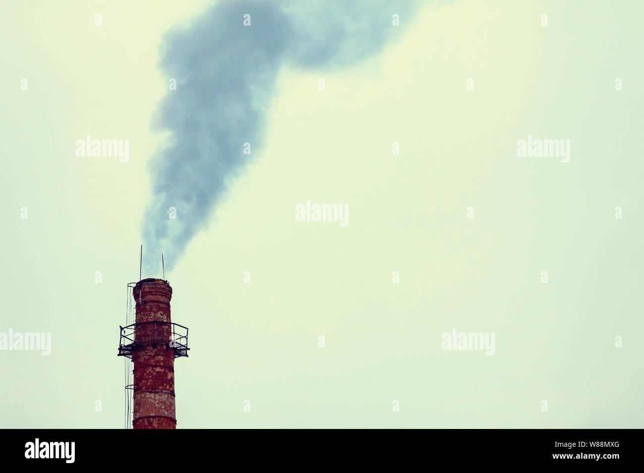 Smoke comes from an old brick chimney Stock Photo - Alamy