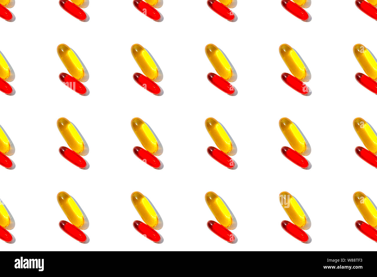 Red and yellow pills pattern isolated on white background Stock Photo ...