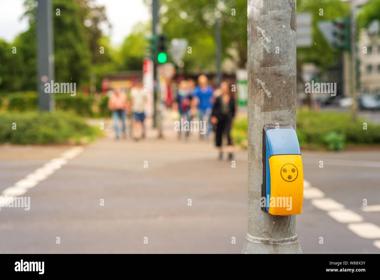 Yellow pedestrian crossing sign or crosswalk push button set up on ...