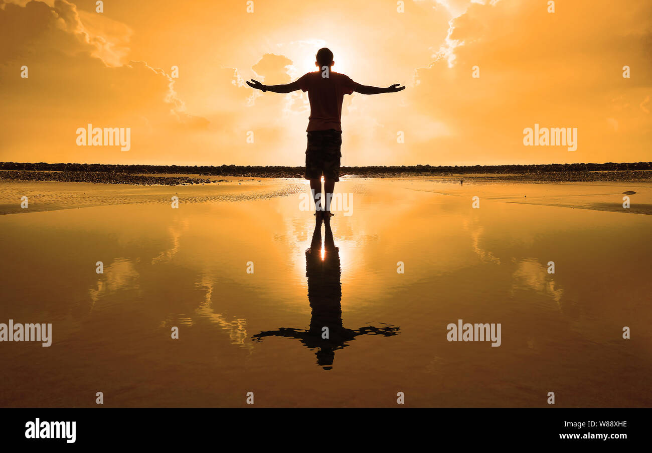 Silhouette of Man Raising His Hands or Open arms when sun rising up ...