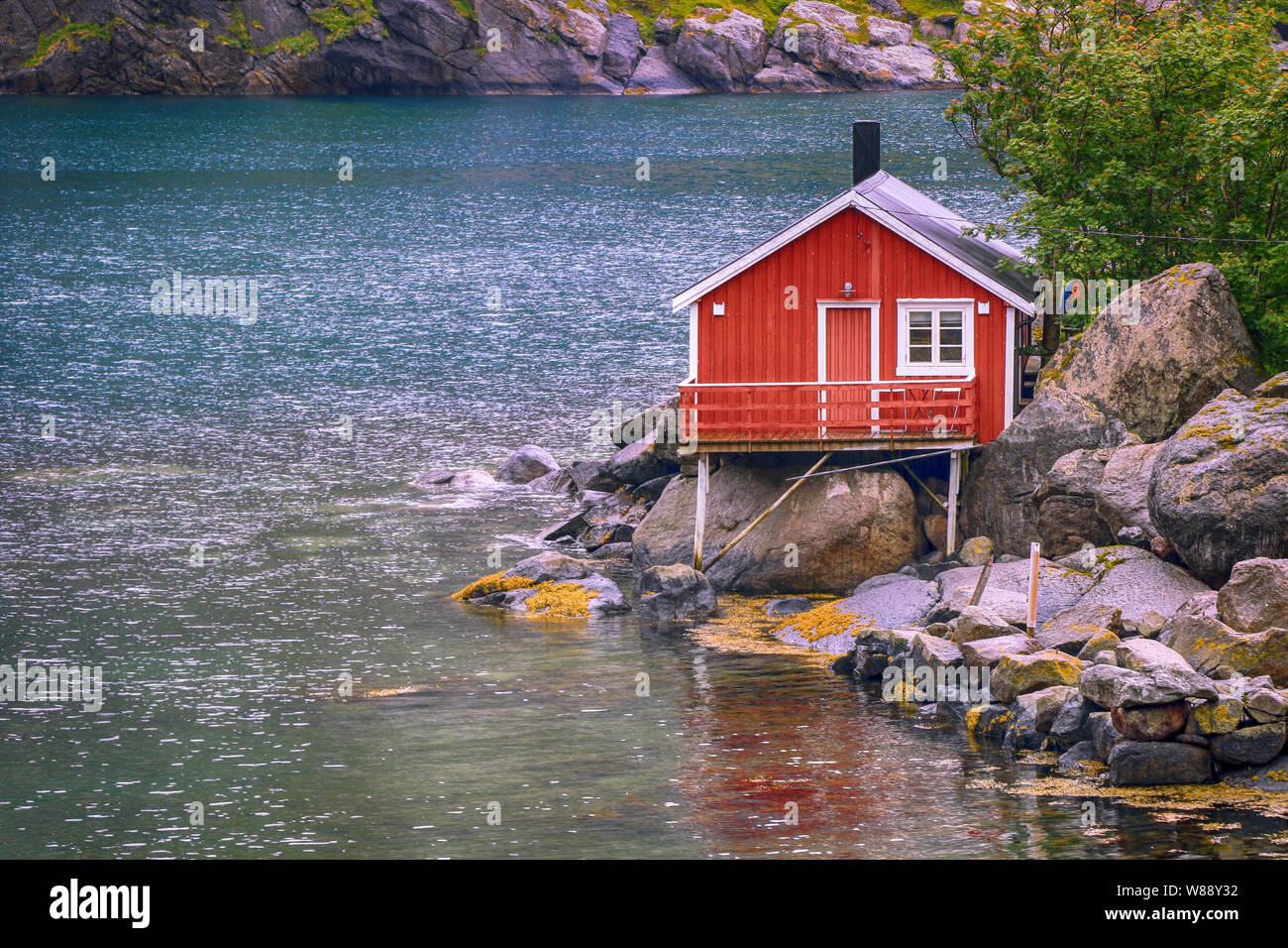 red norwegian fishing house rorbu at the fjord, Lofoten Islands Stock ...