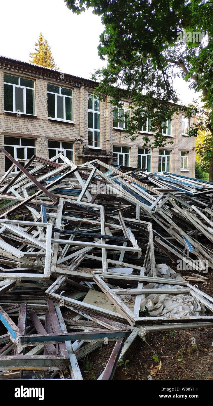 Photo with large pile of old wooden windows that were replaced with ...