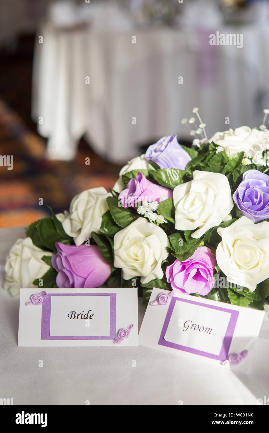 Bride & Groom Name Tags with White & Purple Flowers Stock Photo - Alamy