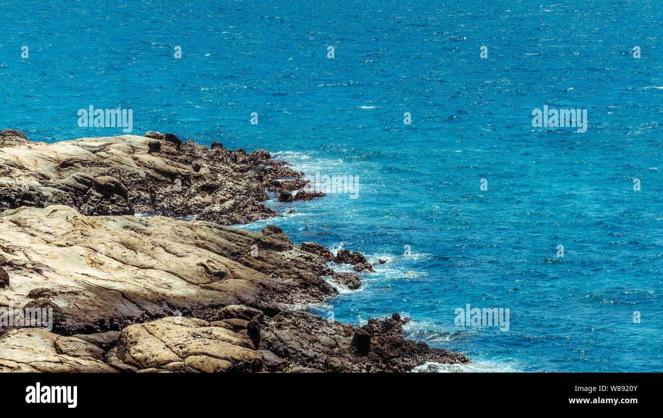 Coast with waves in the tropical Taiwan Island. Sea surfs are splashing ...