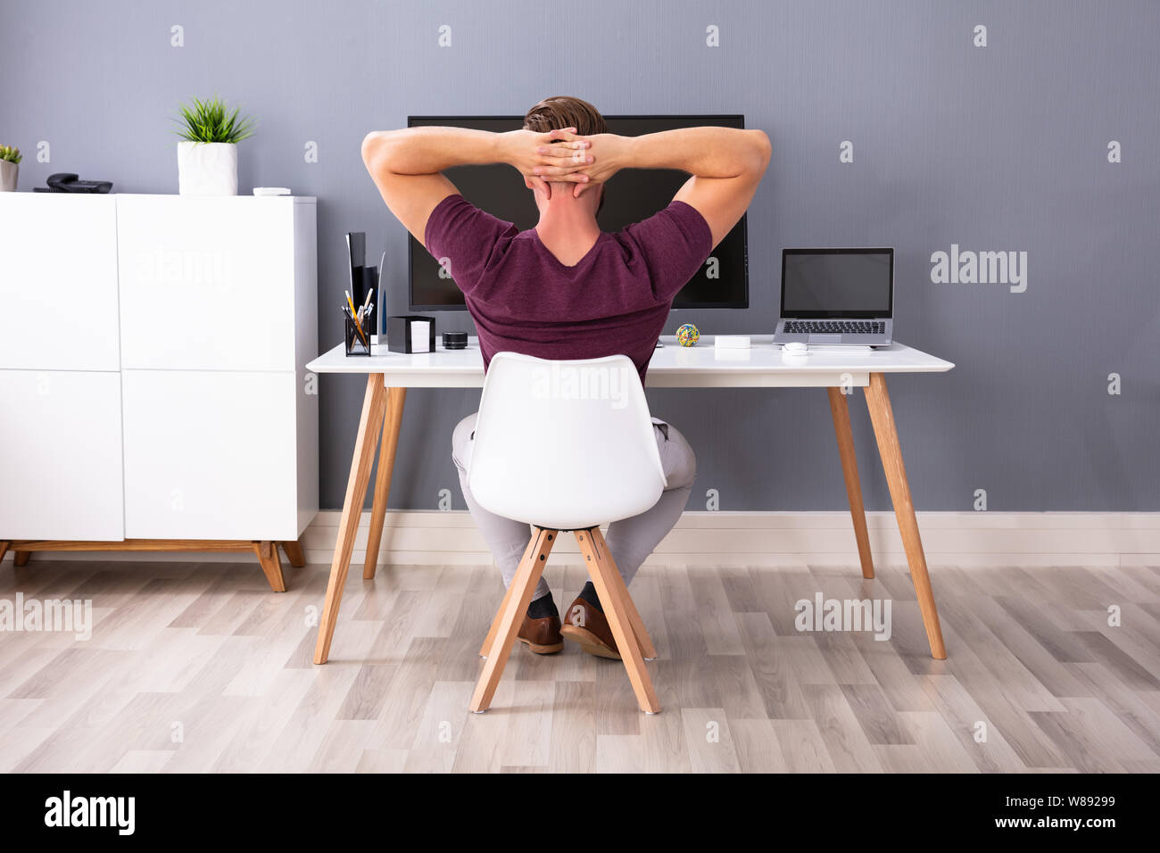 Boss sitting behind desk hi-res stock photography and images - Alamy