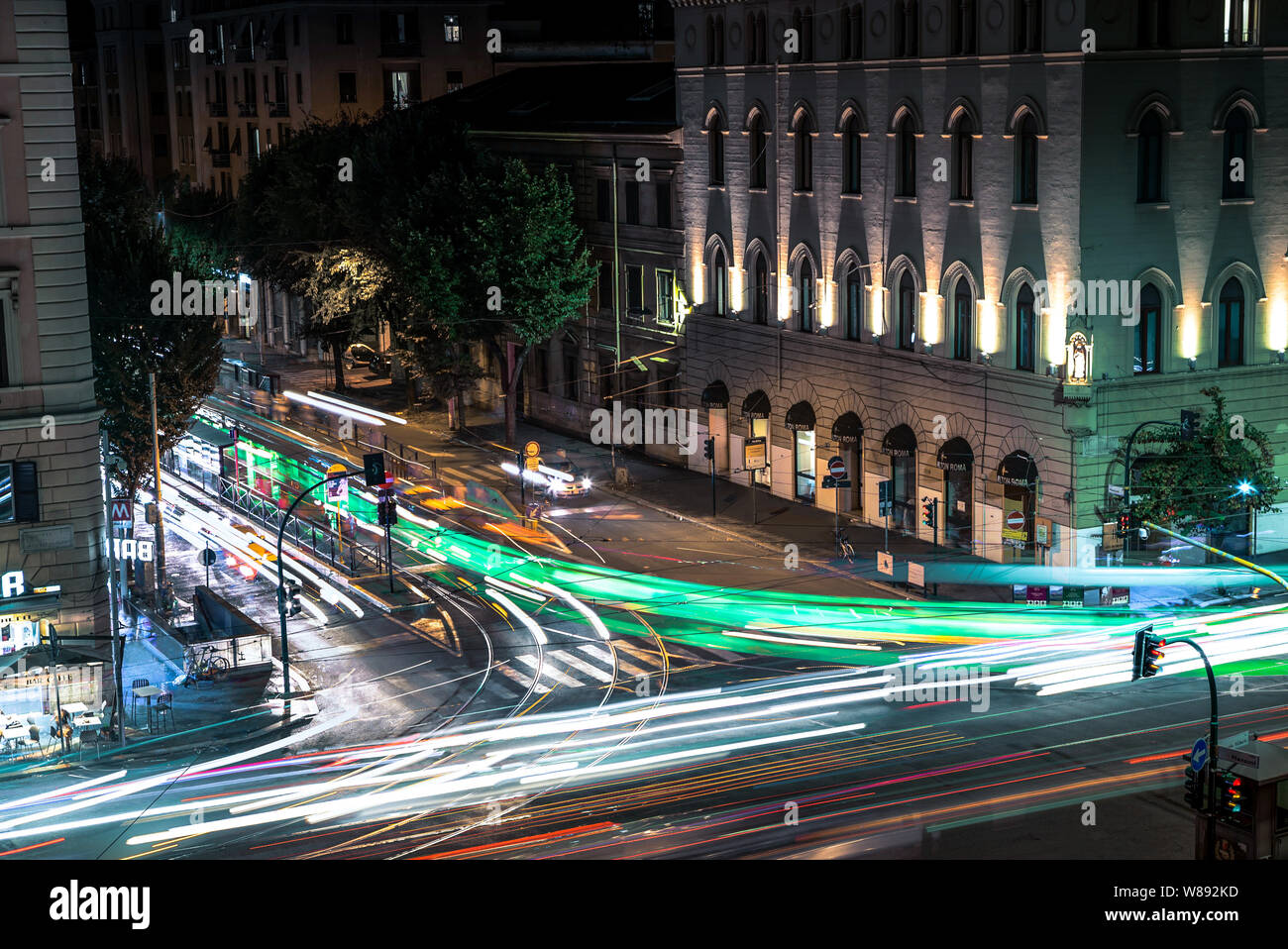 Elevated view over a Rome street with tram rides at night with light ...