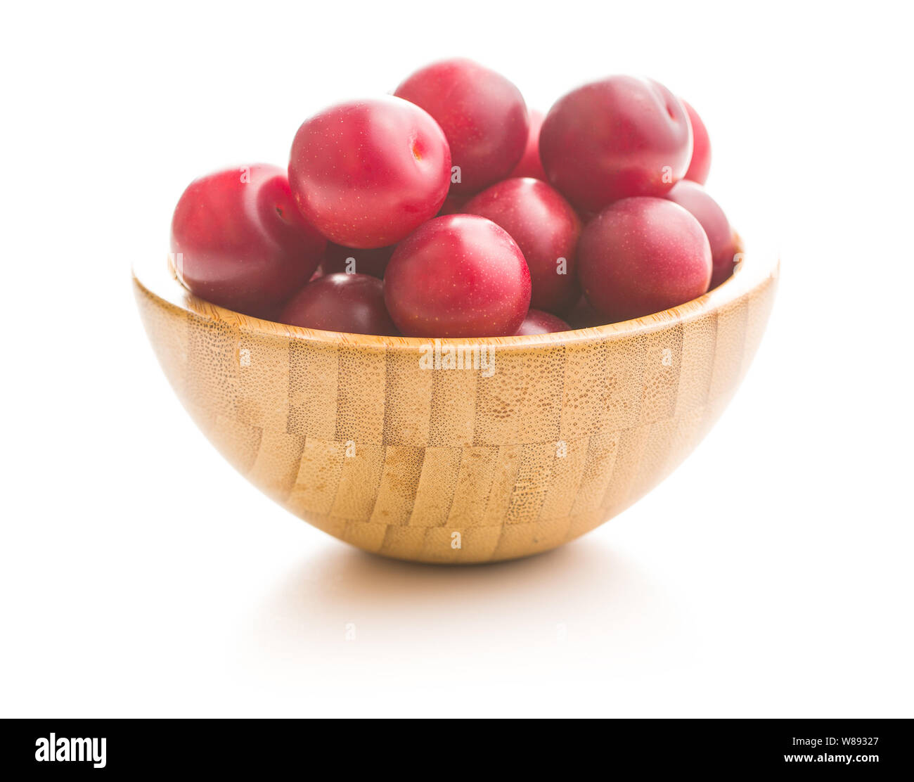 The red cherry plums fruit in bowl isolated on white background Stock ...