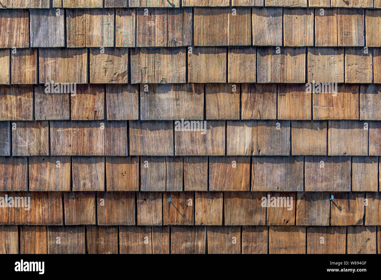 Rough bumpy wood shingle cladding, row of wooden material of small ...