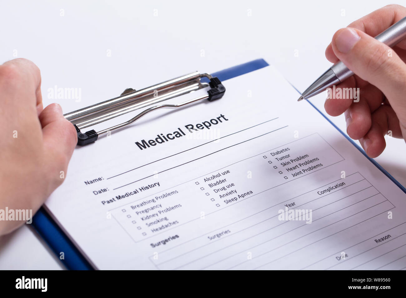 Overhead View Of Human Hand Holding Pen With Medical Report On ...