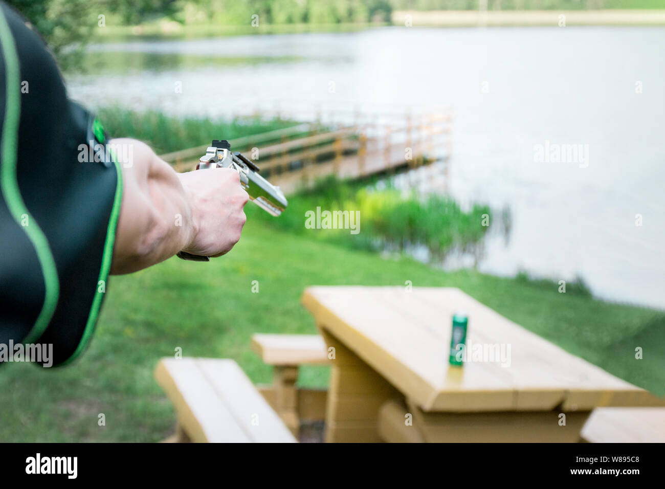 Man shooting revolver green hi-res stock photography and images - Alamy